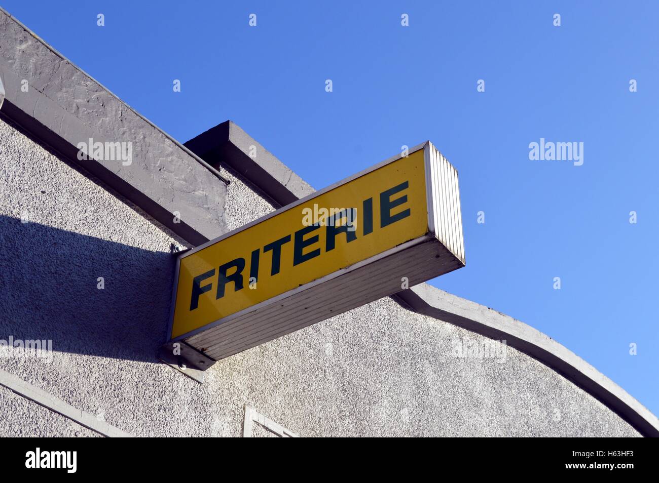 Sign of chip shop of yellow color on a facade Stock Photo - Alamy