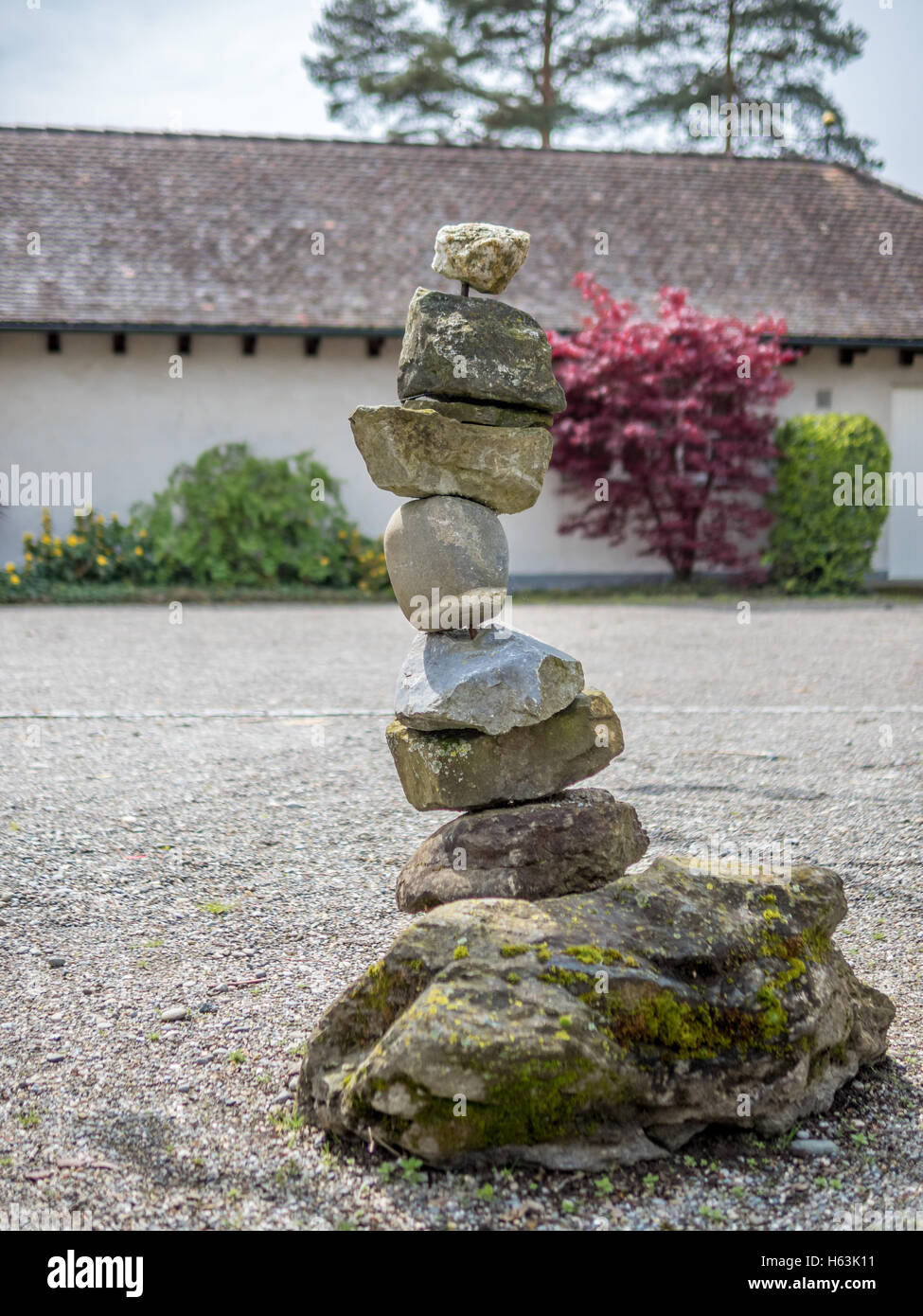 Stack of stones in balance in a garden Stock Photo - Alamy
