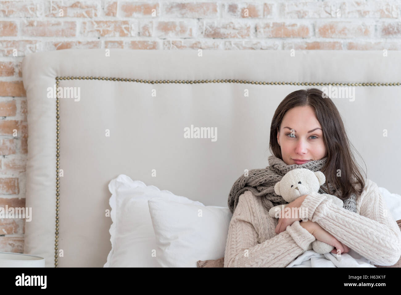 Nice cheerful woman hugging a stuffed toy Stock Photo - Alamy