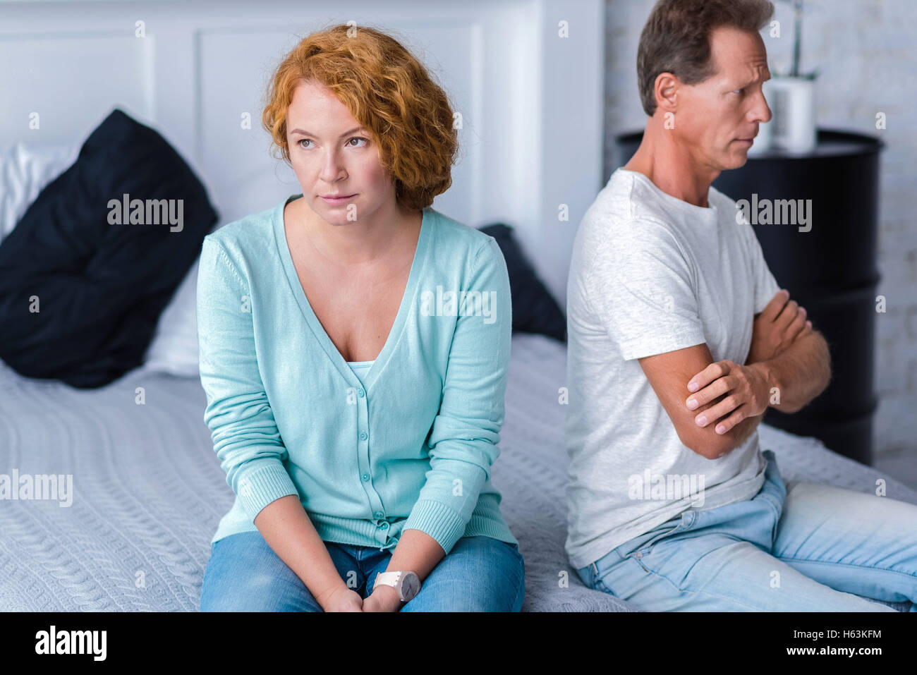 Depressed aged couple sitting on the bed Stock Photo - Alamy