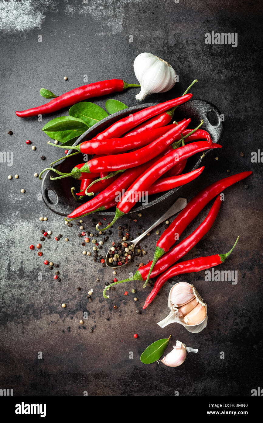 red hot chili pepper corns and pods on dark old metal culinary ...