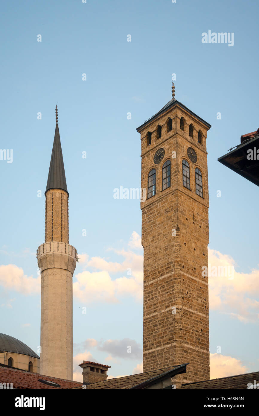 The minaret of the Ferhadija Mosque, and a clock tower, in Sarajevo ...