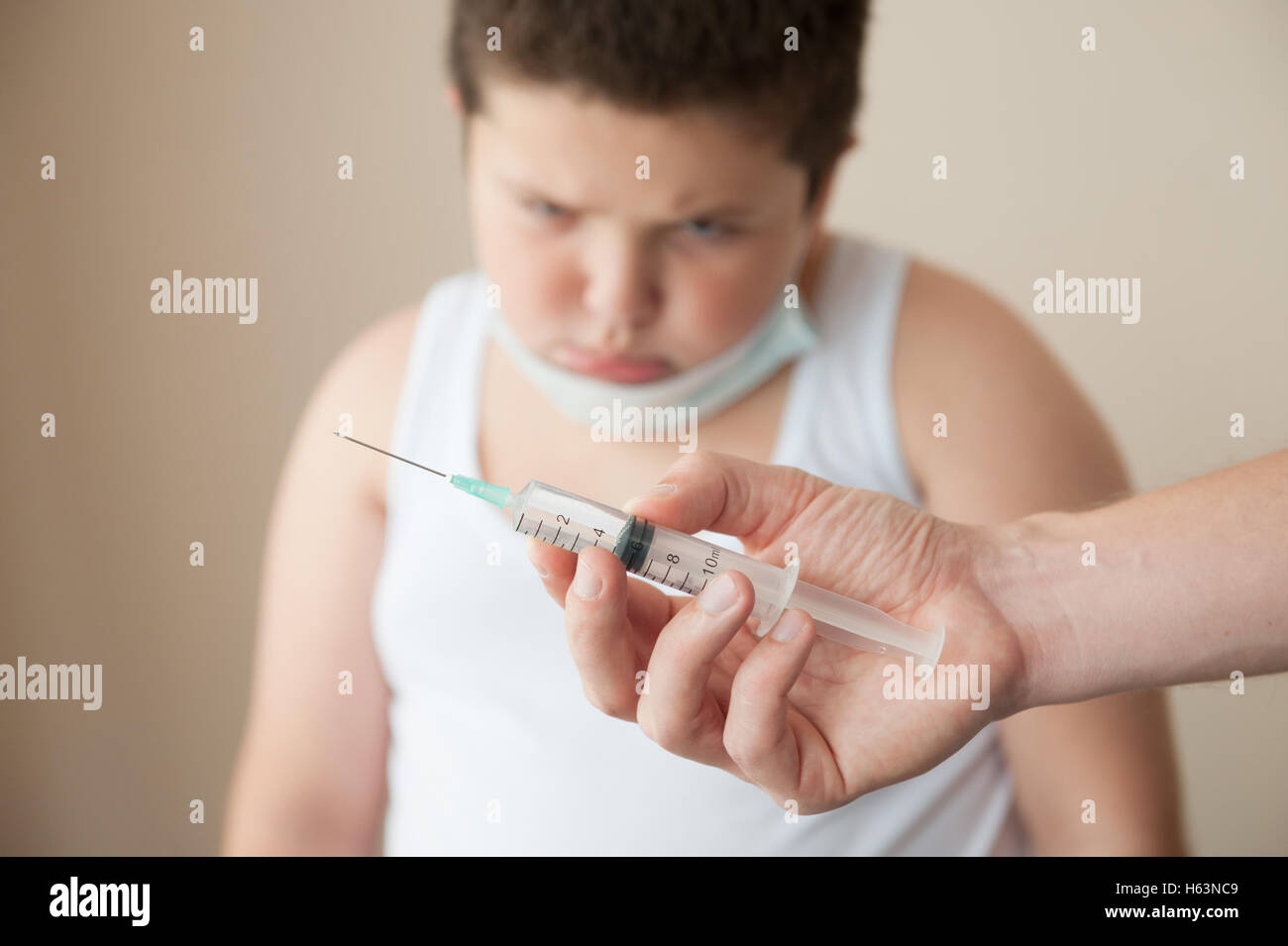 syringe before sad fat boy who fear injections Stock Photo - Alamy