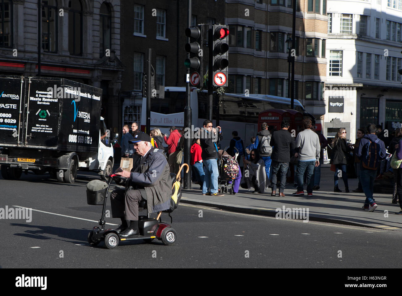 London, UK - July 17, 2016. Elderly man drive mobility scooter through ...