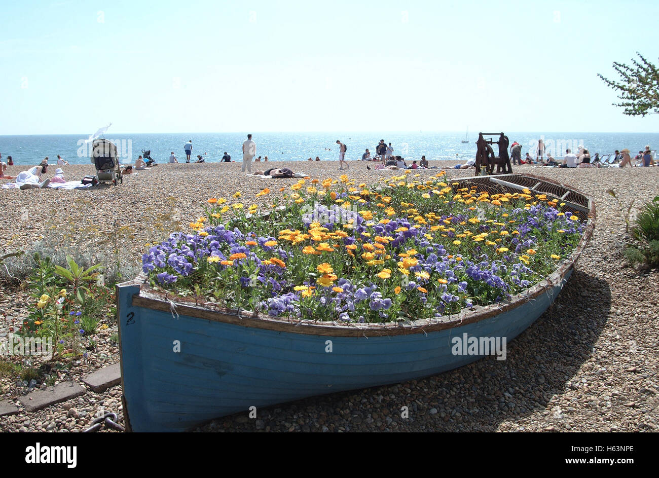 Flower filled boat on Brighton beach Stock Photo - Alamy