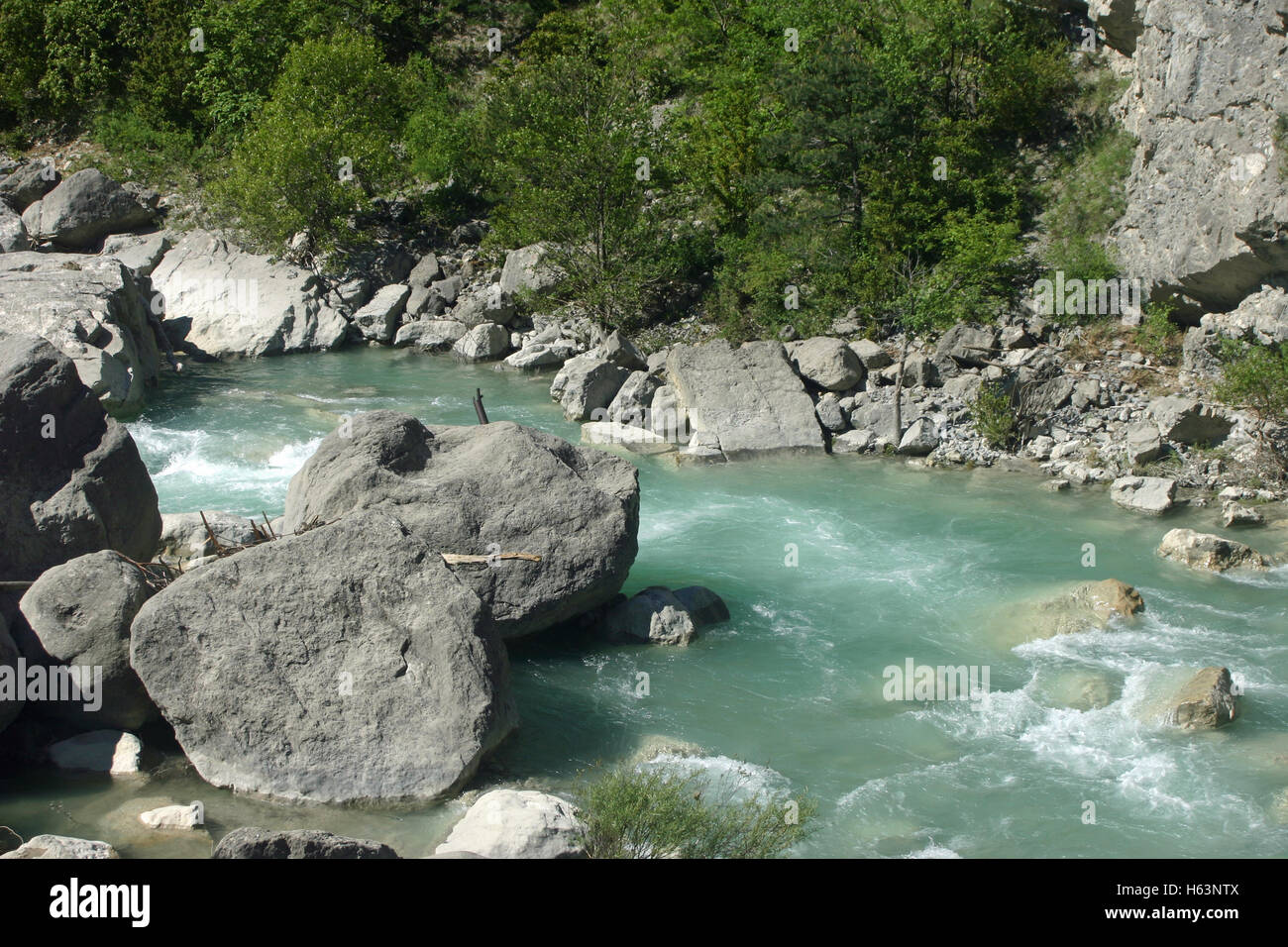 Pale blue fast flowing french river Stock Photo - Alamy