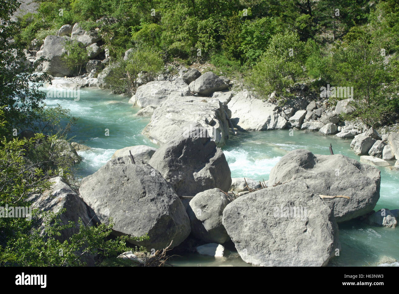 Pale blue fast flowing french river Stock Photo - Alamy