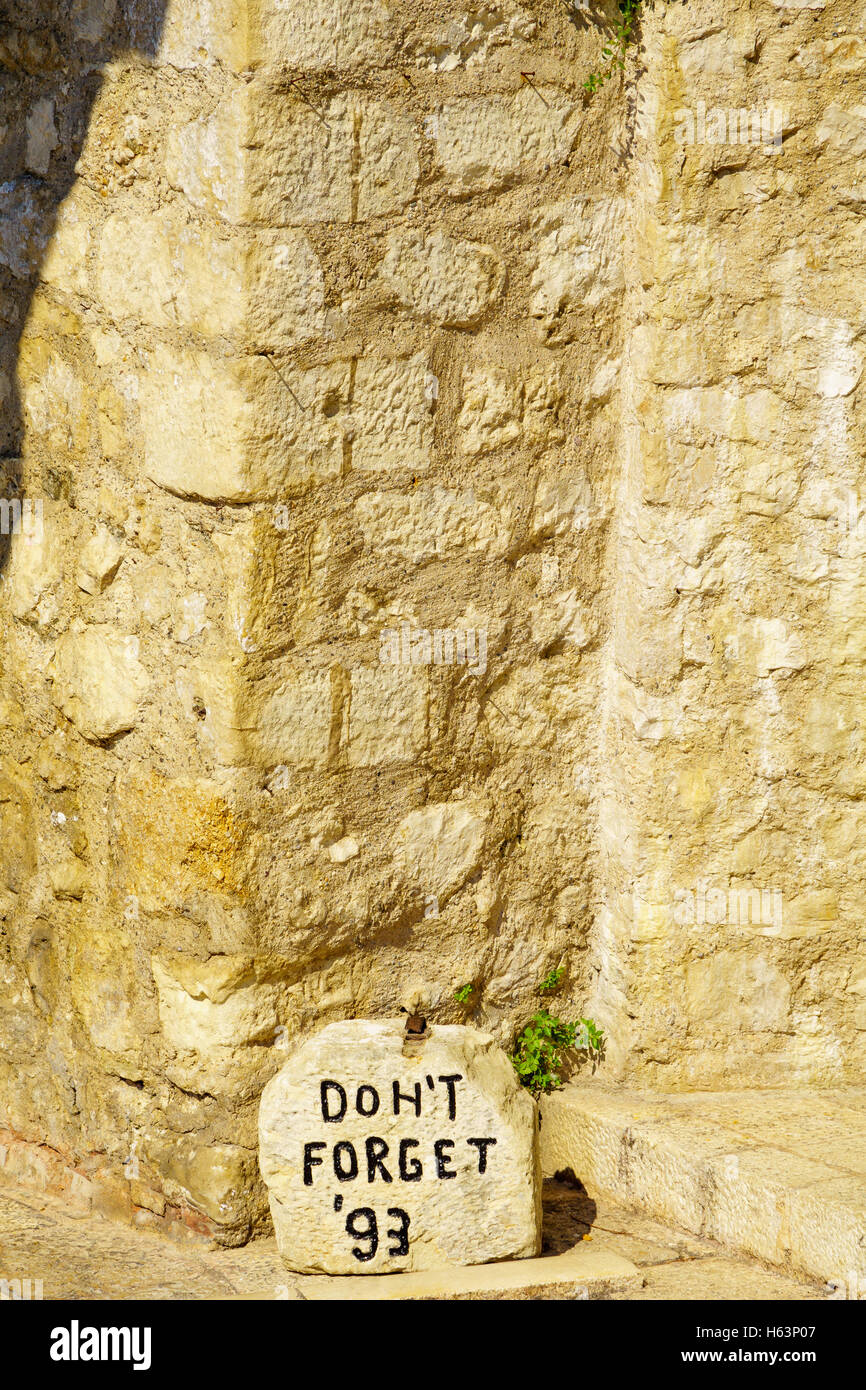 A war memorial sign on a stone, in the old city of Mostar, Bosnia and ...