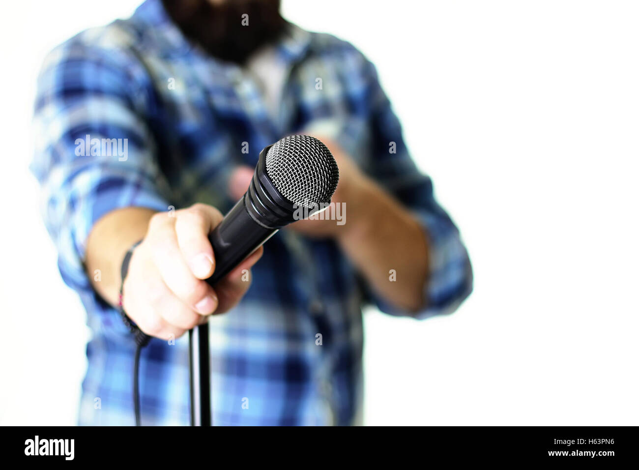 microphone on stage hand hold Stock Photo - Alamy