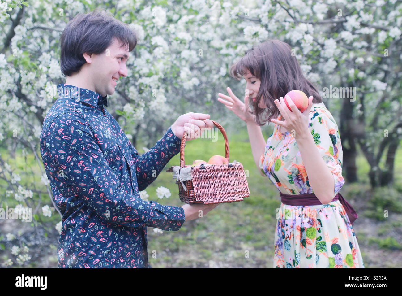 couple in love outdoor apple tree picnic Stock Photo - Alamy