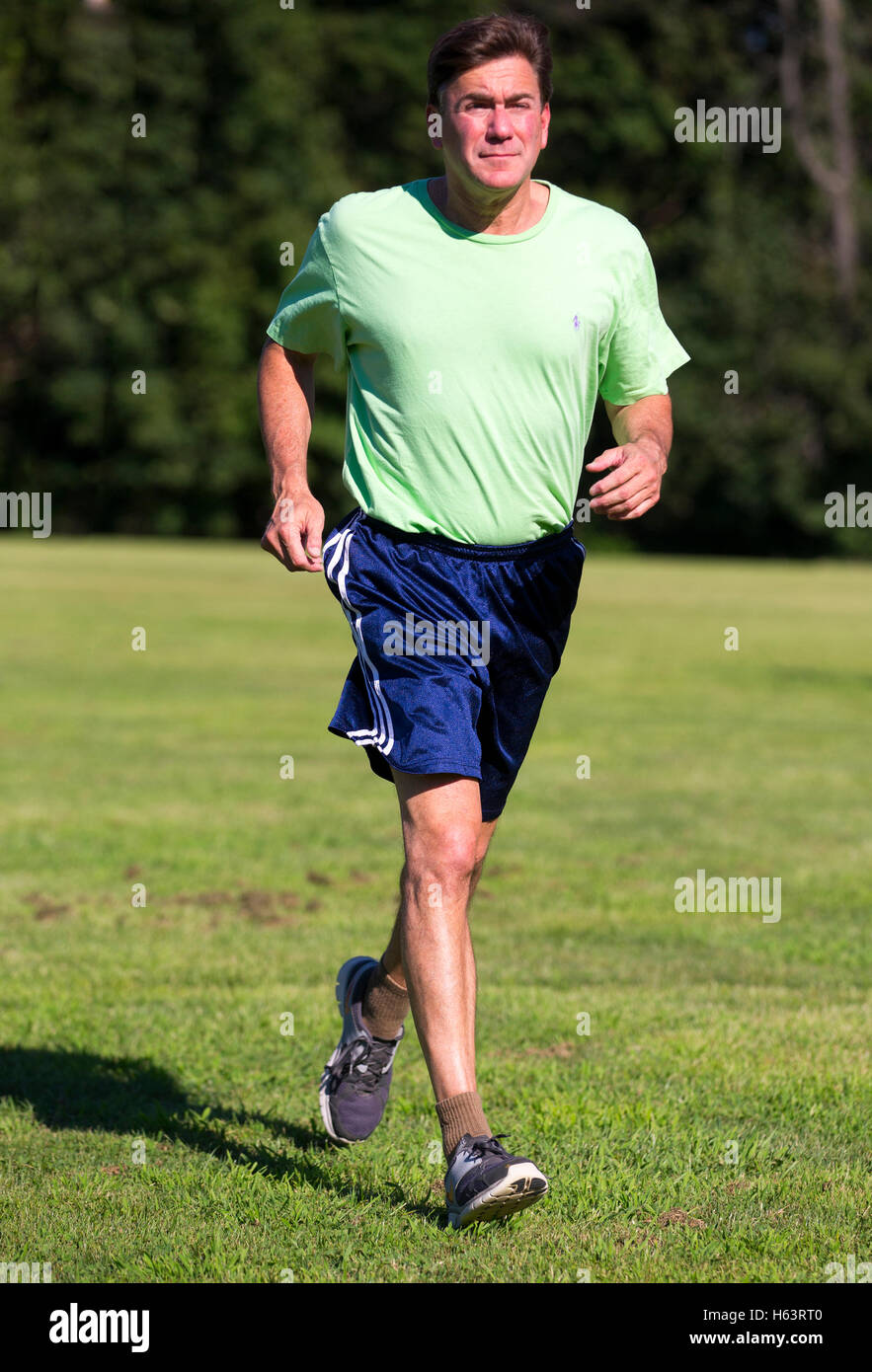 Man jogging in a park Stock Photo - Alamy