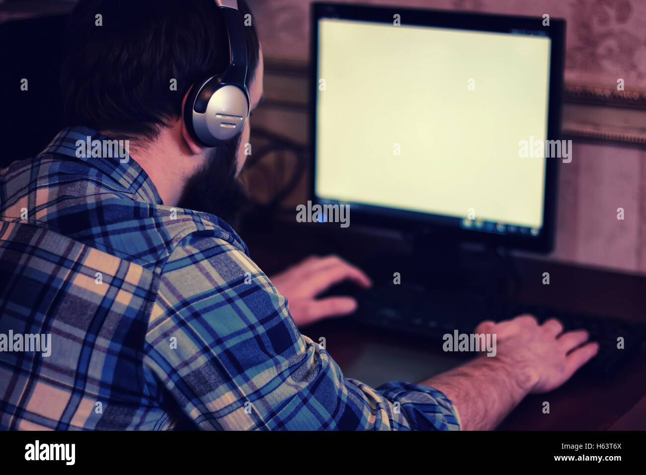 male behind computer with headphones Stock Photo - Alamy