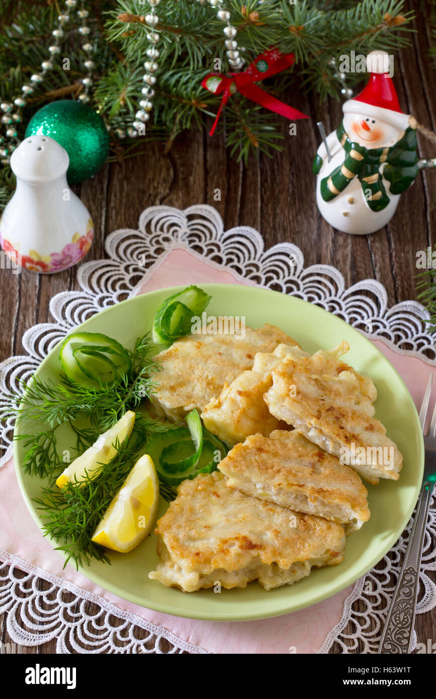 Fried fish in batter potato on a wooden Christmas table Stock Photo - Alamy