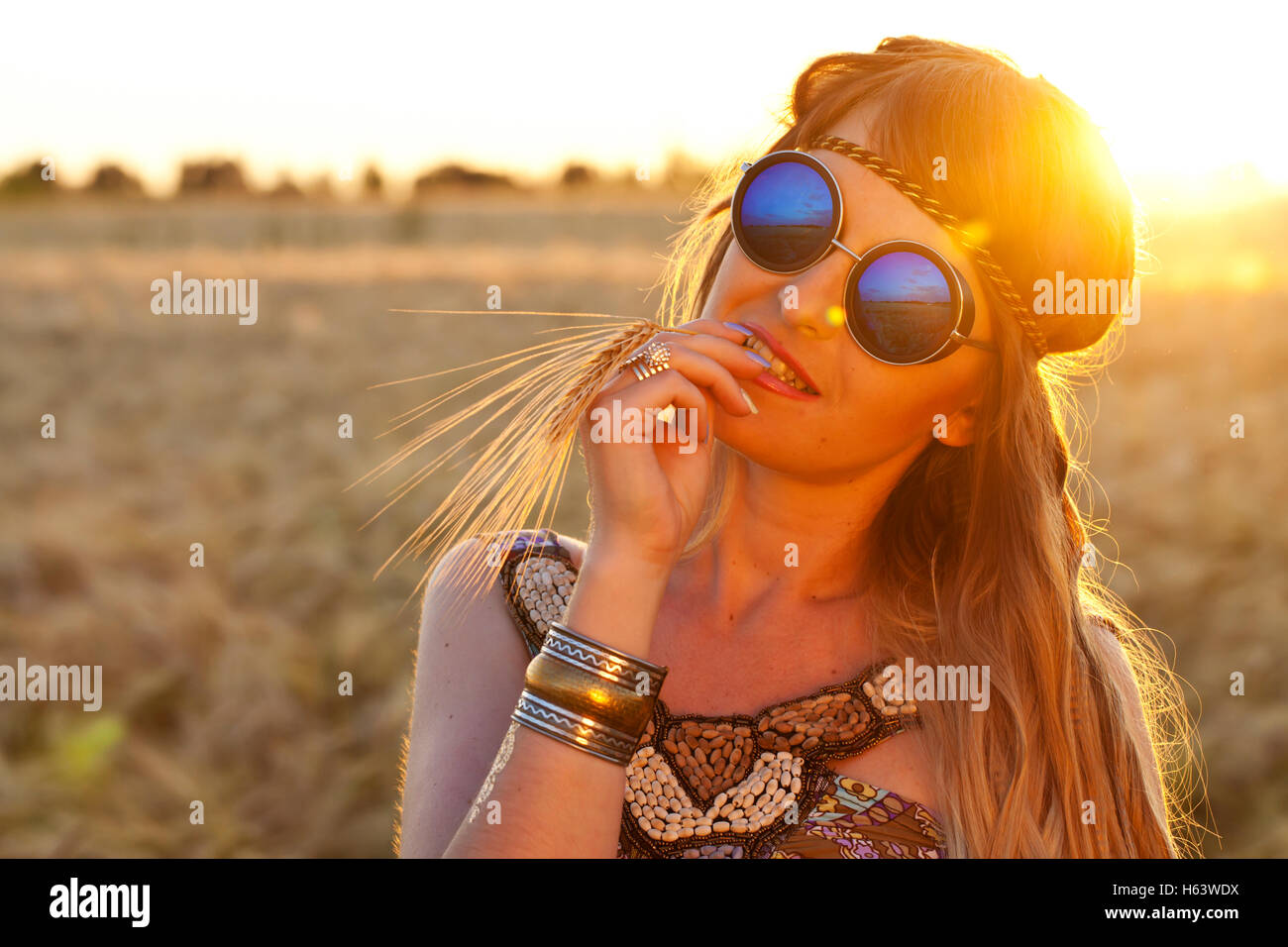 a Beautiful hippie girl at sunset Stock Photo - Alamy