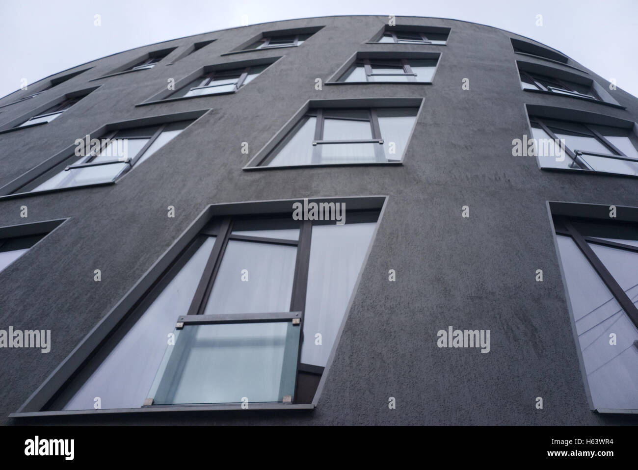 Black building with strange asymmetric windows Stock Photo - Alamy