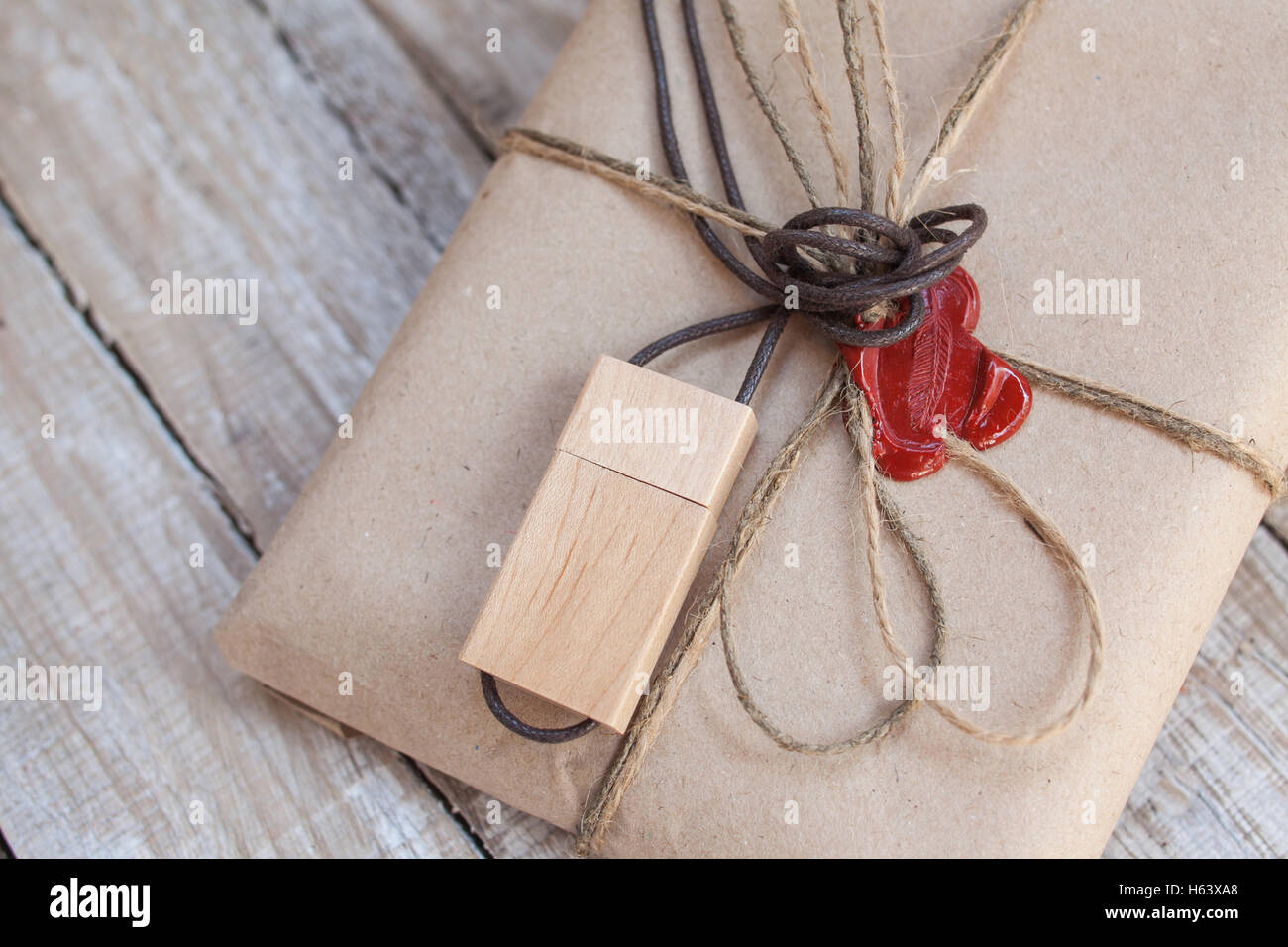 The parcel wrapped in Kraft on a wooden background Stock Photo - Alamy