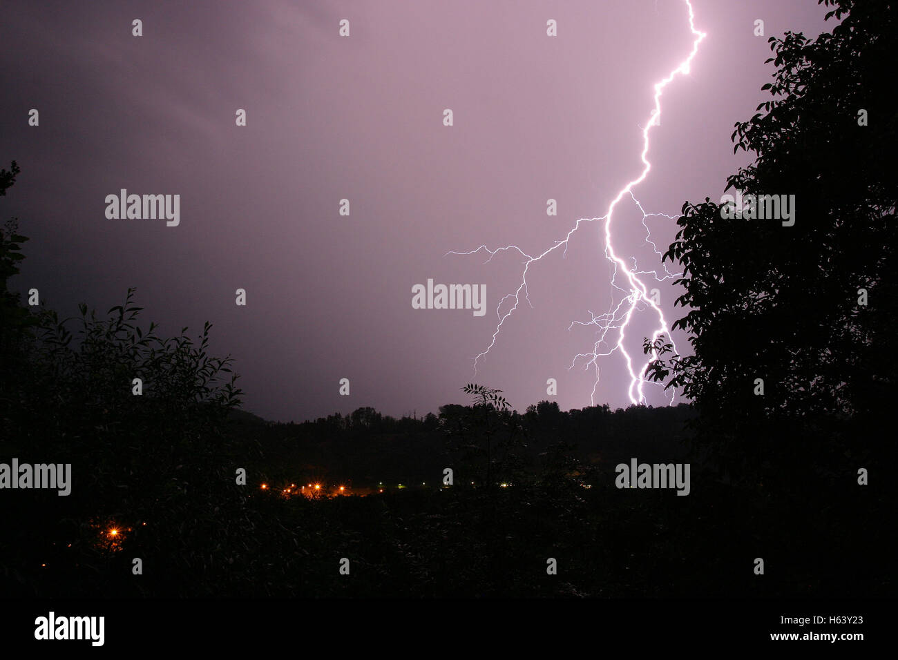 thunderstom at night with lightning bolt in background Stock Photo - Alamy