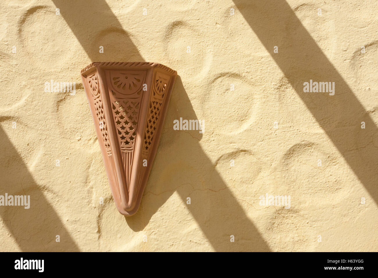 shadow lines across clay wall lamp Stock Photo - Alamy