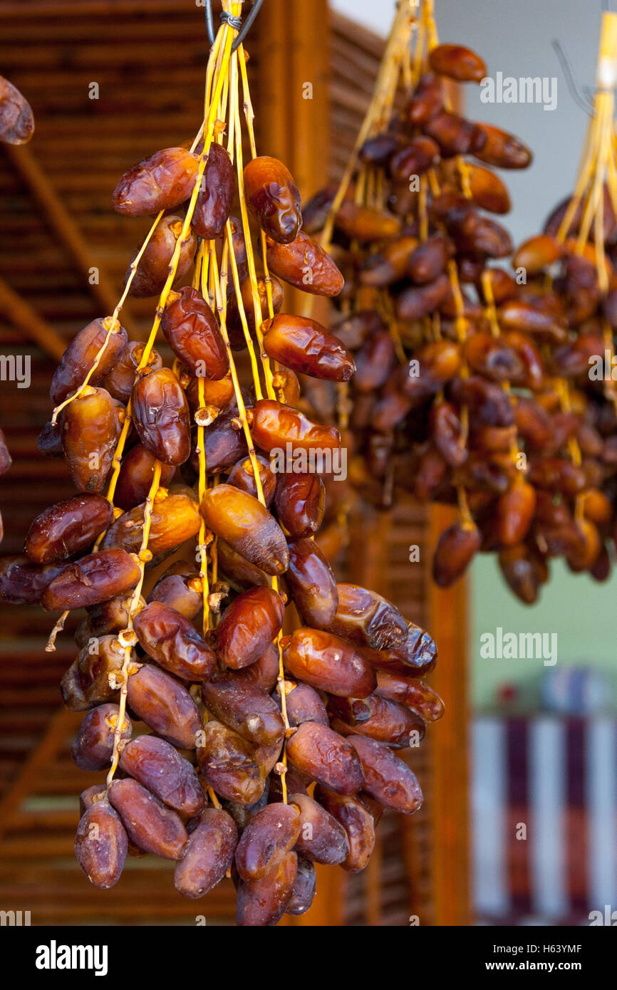 dates hanging in market Stock Photo - Alamy