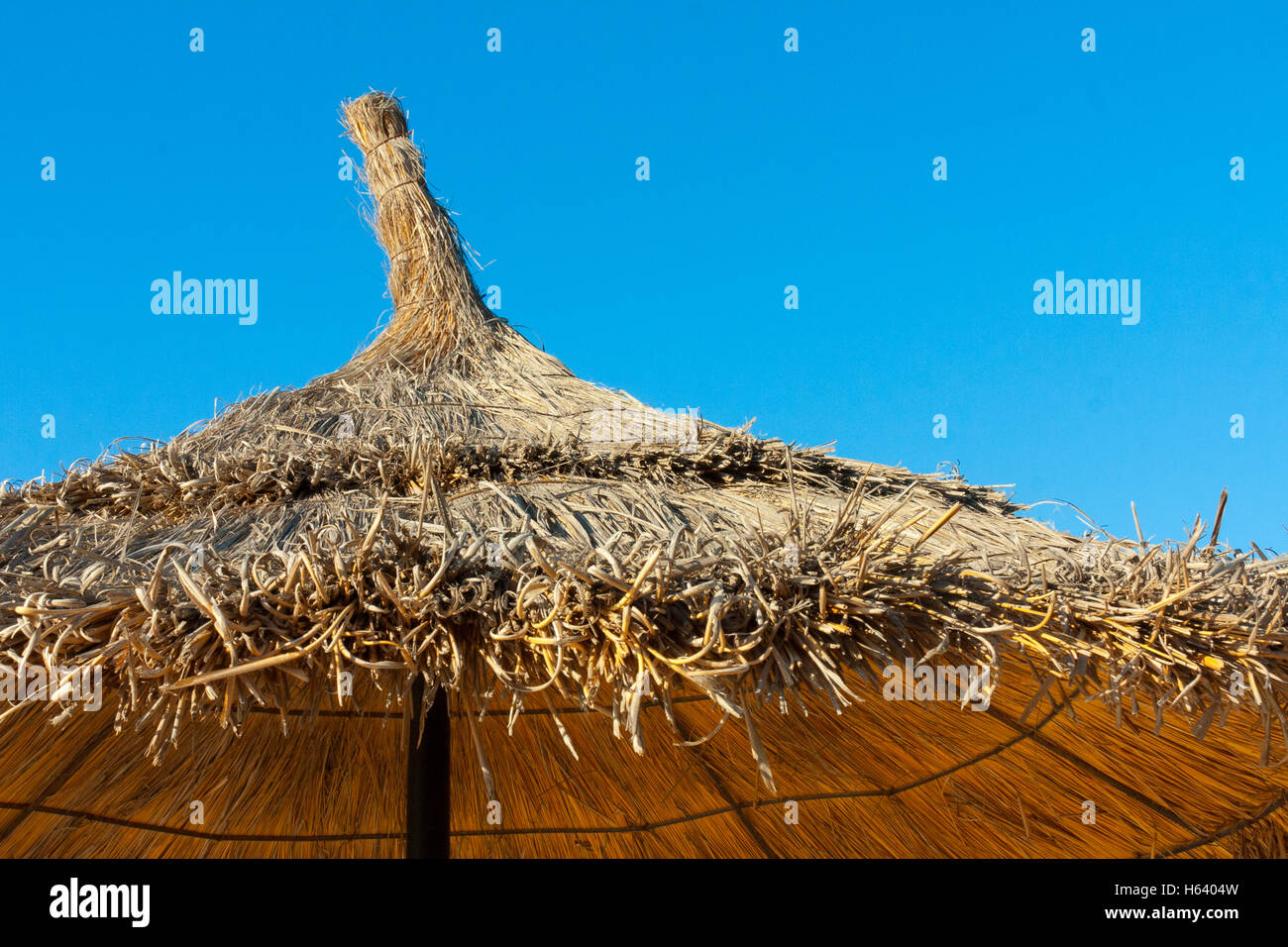 straw parasol against blue sky Stock Photo - Alamy