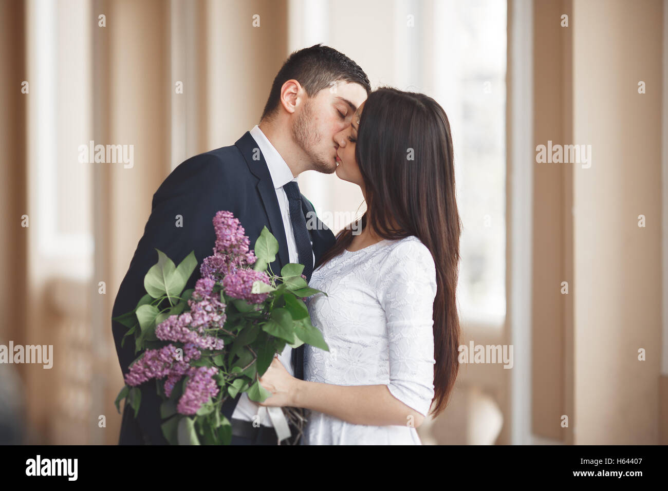 Beautiful couple, bride and groom posing near big white column Stock ...