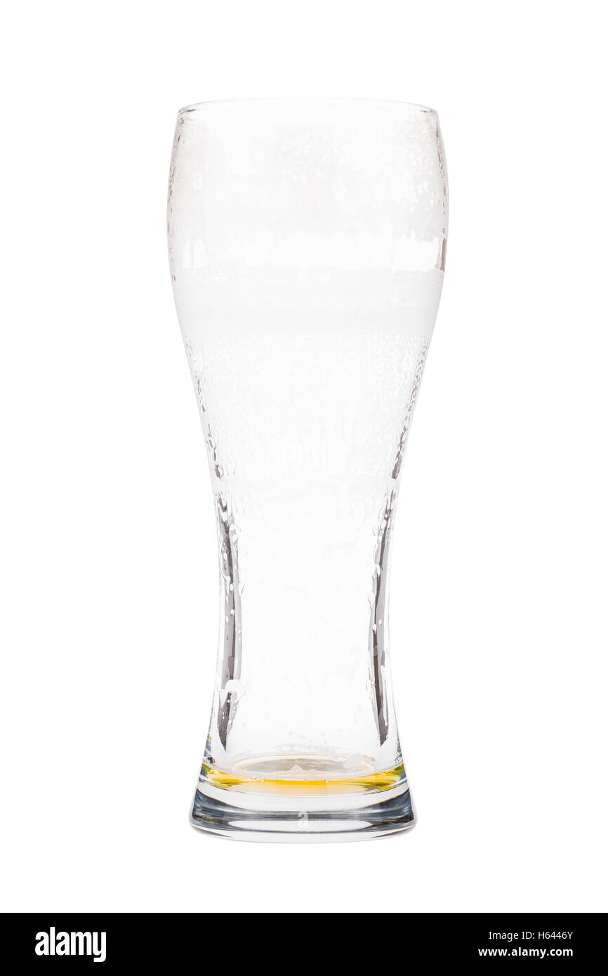 Almost empty beer glass. Light lager beer remains in a tall glass ...