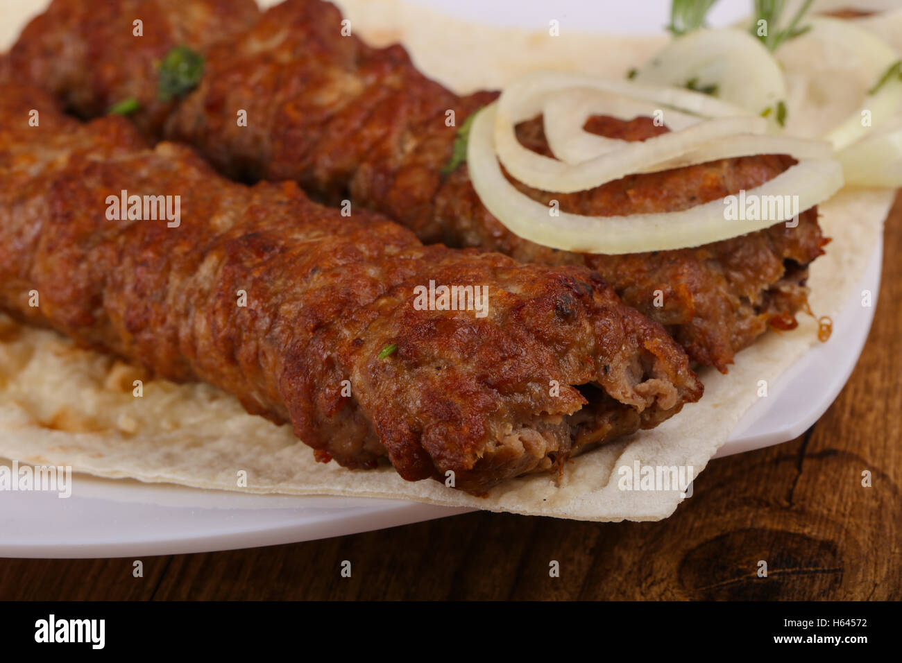 Hot Juicy Grilled Kebab with onion and parsley Stock Photo - Alamy
