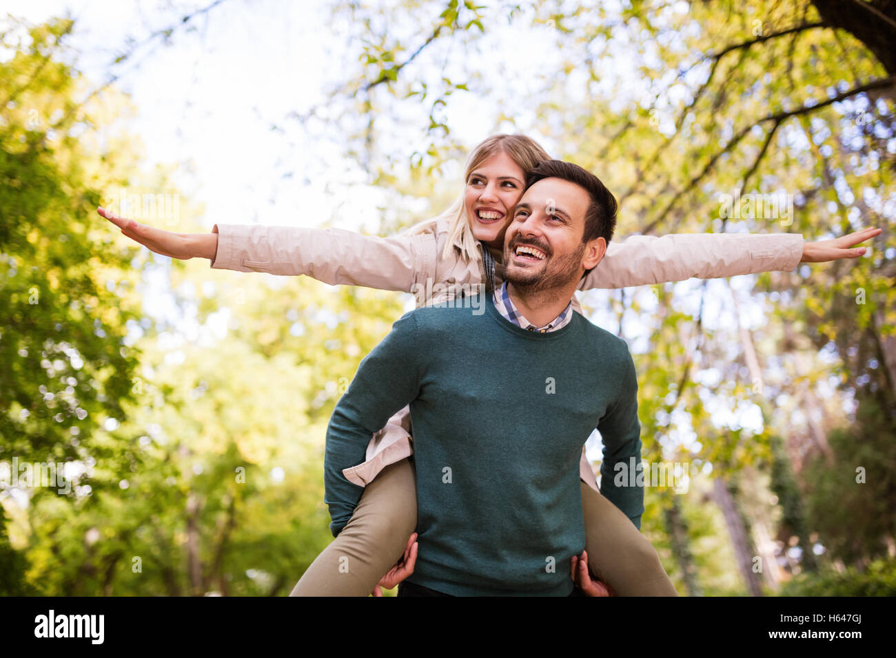 Loving happy couple walking in a park Stock Photo - Alamy