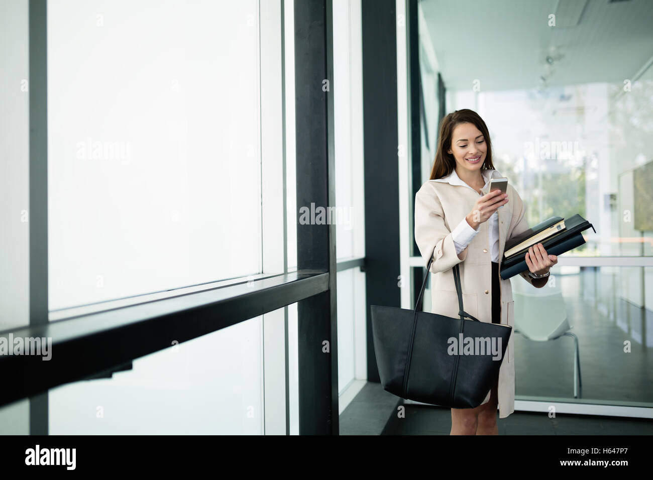 Company CEO busy talking on phone while holding folders Stock Photo - Alamy