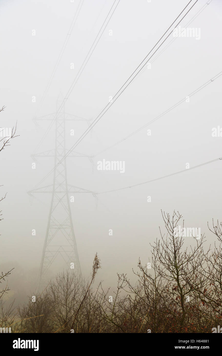 Electricity pylons shrouded in early morning mist Stock Photo - Alamy