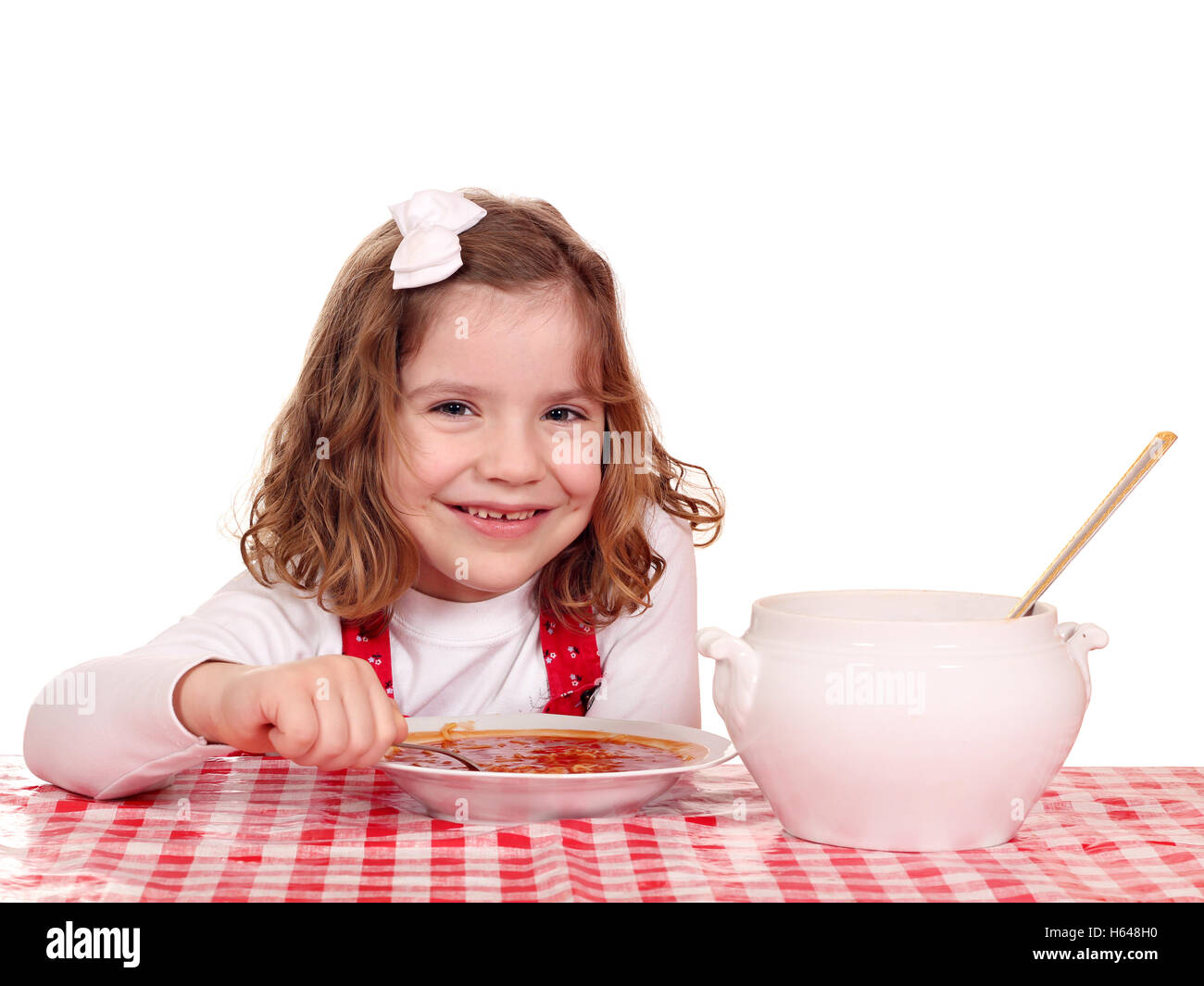happy little girl eat tomato soup Stock Photo - Alamy