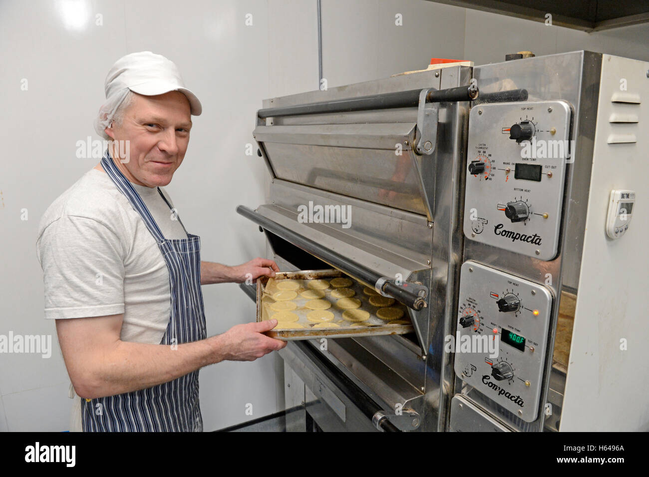 Baker making recipes and baking cakes and loaves in an oven Stock Photo ...