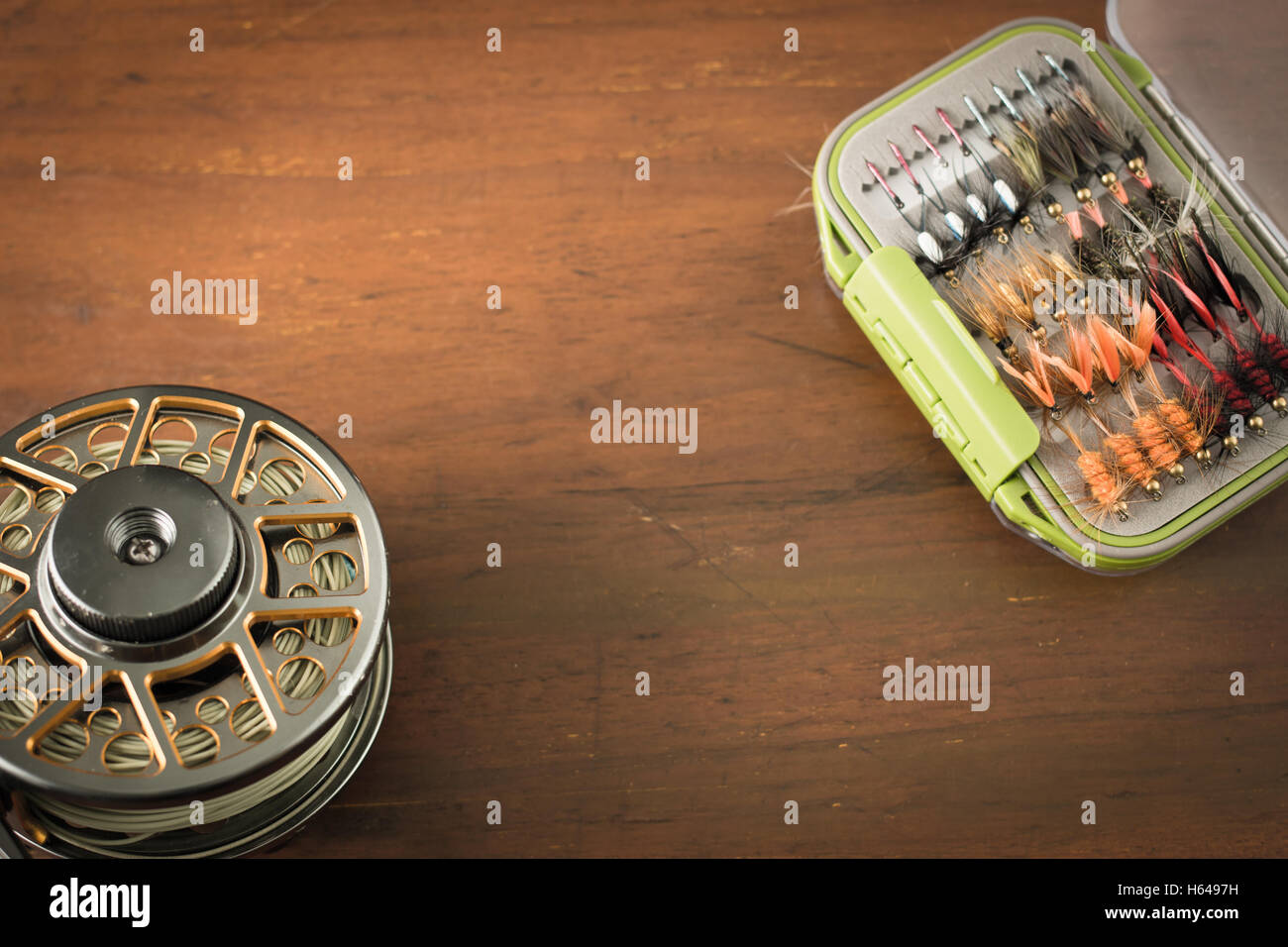 Fly fishing gear, which includes a reel and containers of flies with ...