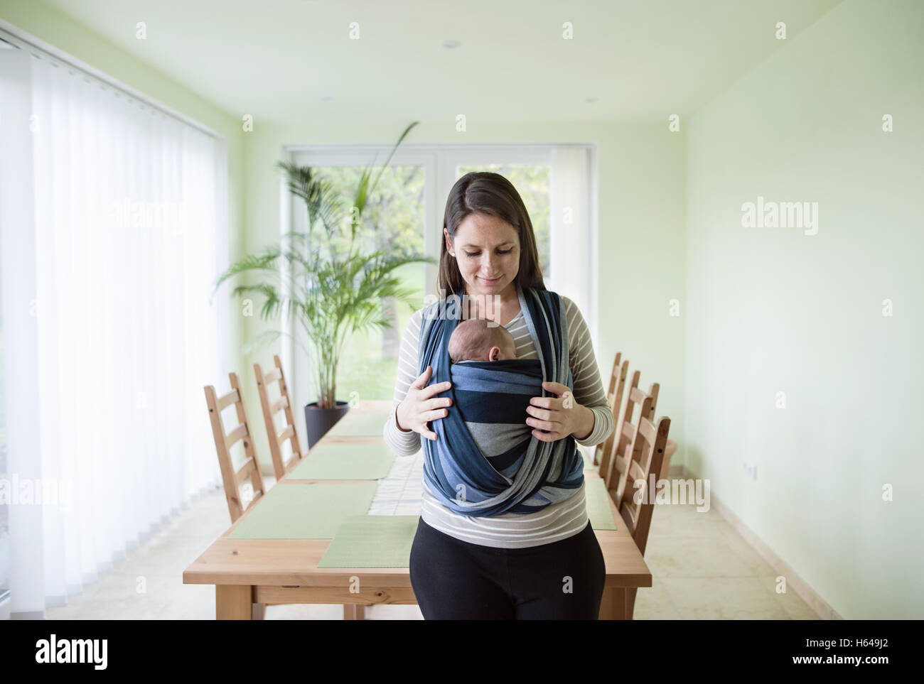 Beautiful young mother with her son in sling Stock Photo - Alamy