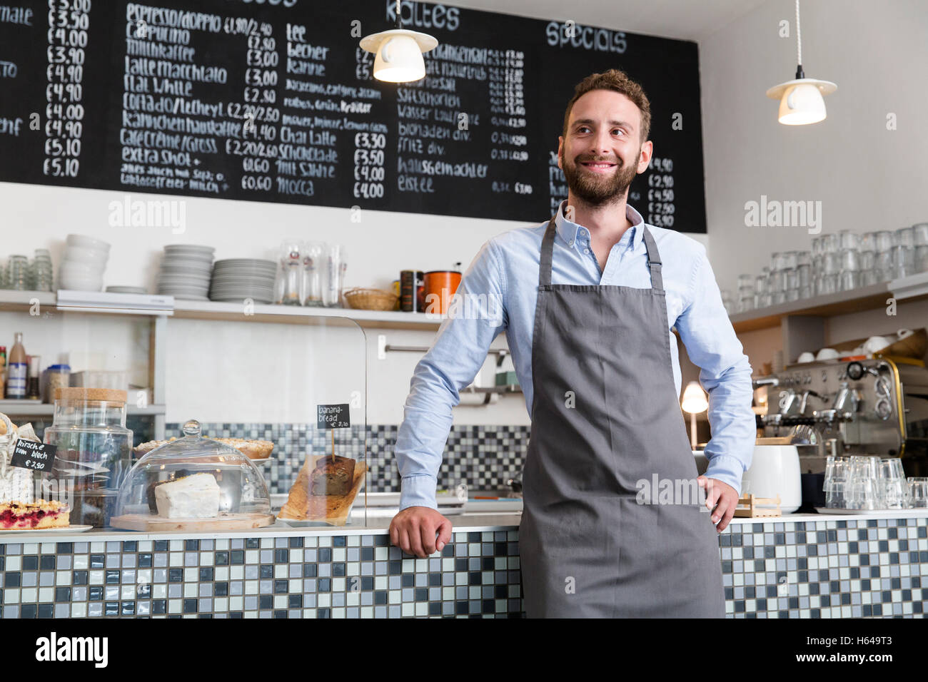 Smiling barista in a cafe Stock Photo - Alamy
