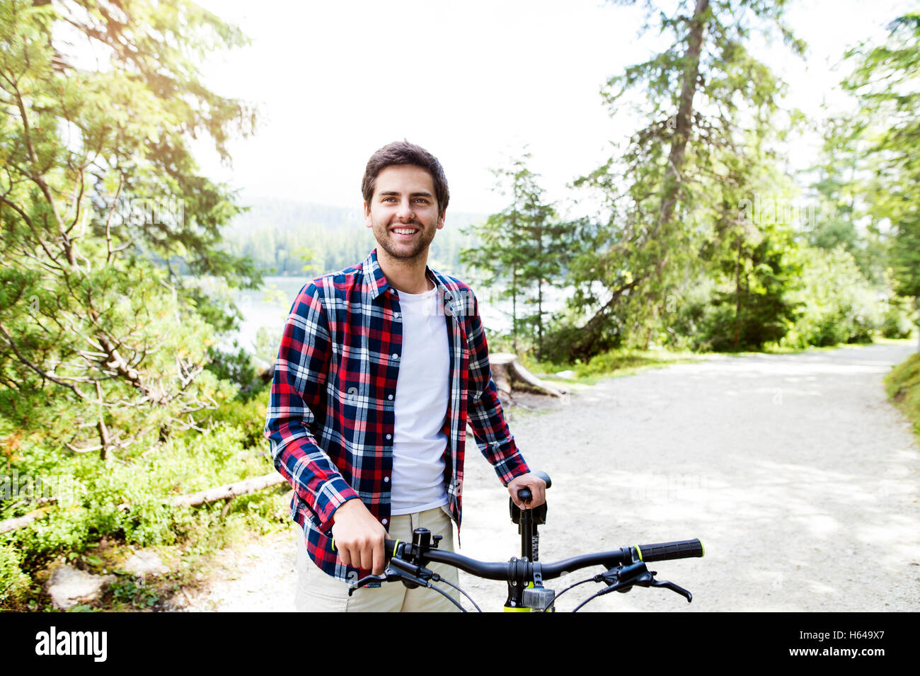 Young man riding bicycle in nature Stock Photo - Alamy
