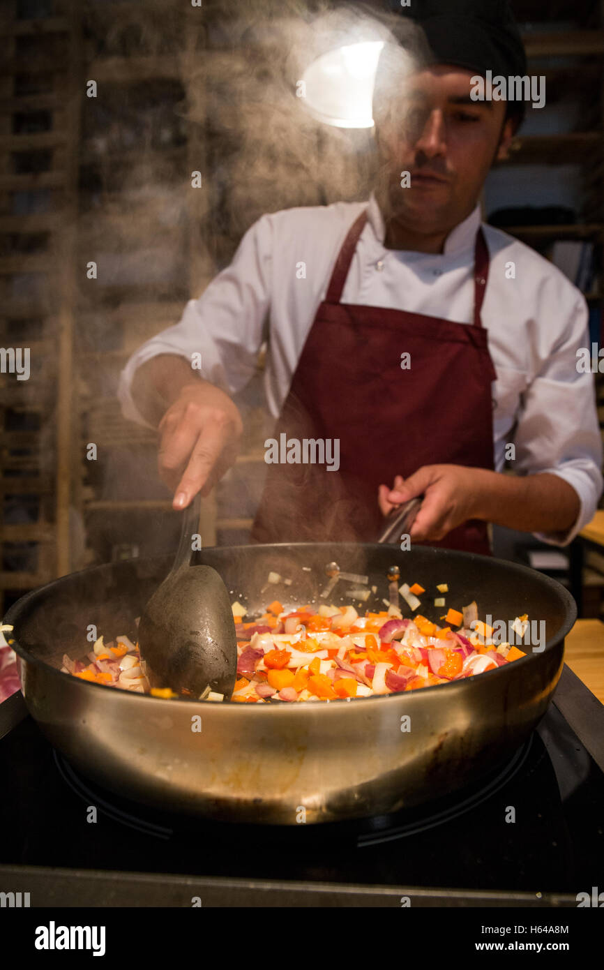 Man sauting vegetables in a pan Stock Photo - Alamy