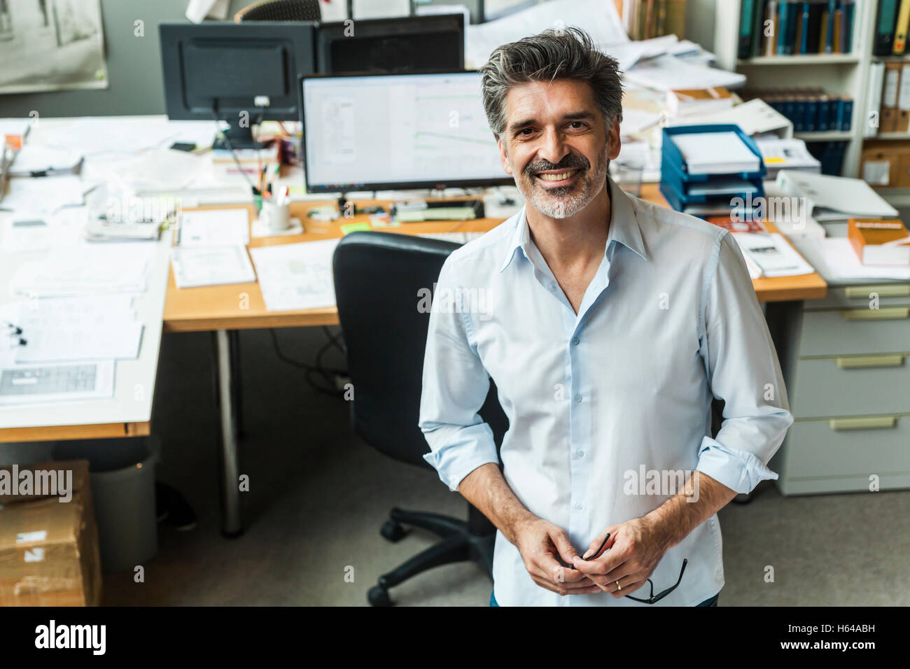 Successful architect standing in his office Stock Photo - Alamy