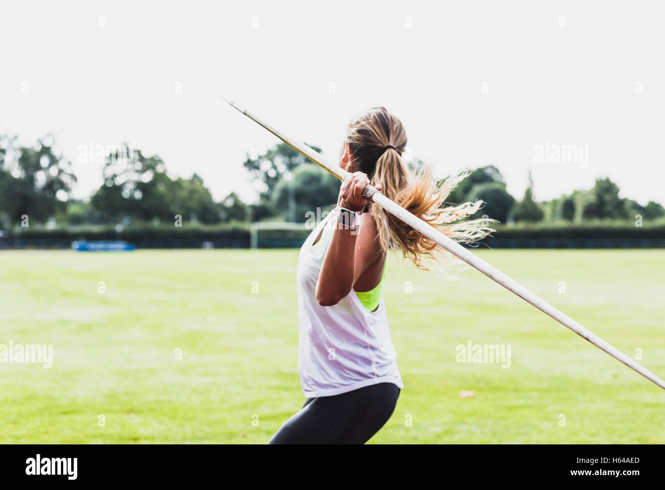 Young woman throwing javelin Stock Photo - Alamy