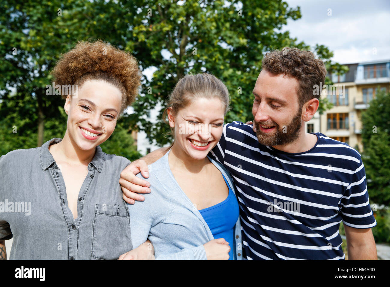Three happy friends outdoors Stock Photo - Alamy