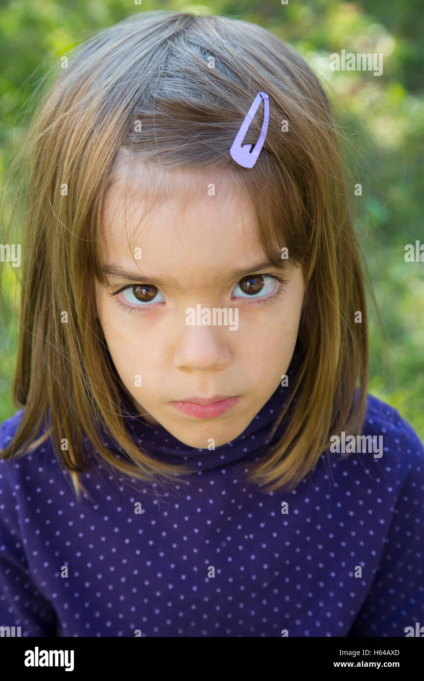Little girl looking serious, portrait Stock Photo - Alamy