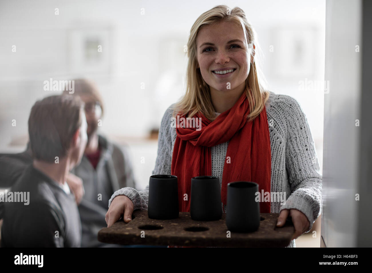 Young woman serving coffee Stock Photo - Alamy