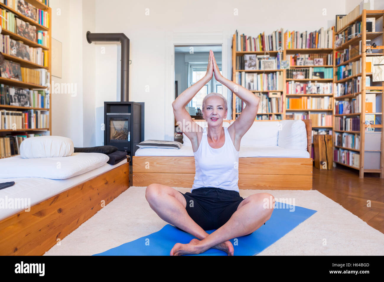 Woman practicing yoga at home Stock Photo - Alamy