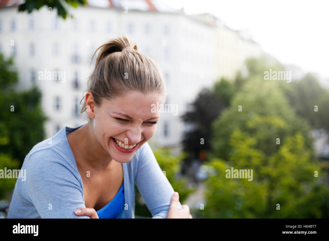Laughing young woman outdoors Stock Photo - Alamy