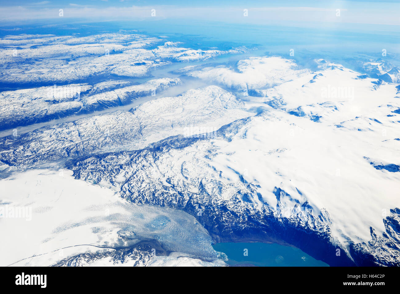 Greenland, view out of plane window on glaciers, fjords, sea and ...