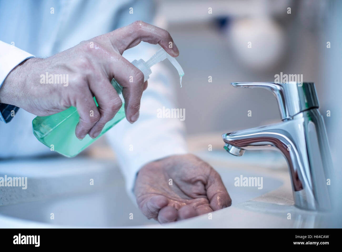 Doctor washing hands with soap Stock Photo - Alamy