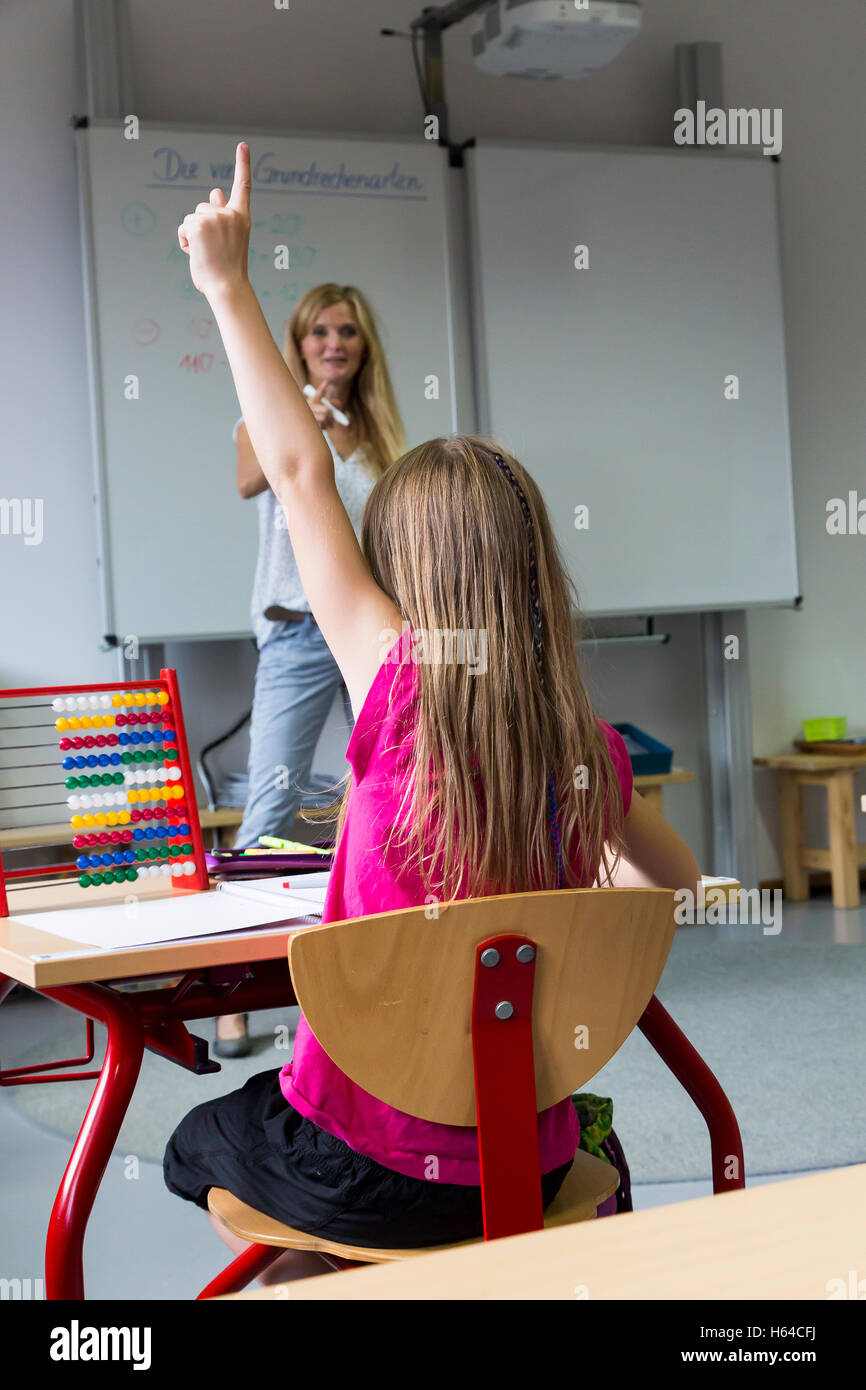 Back view schoolgirl raising hand hi-res stock photography and images ...
