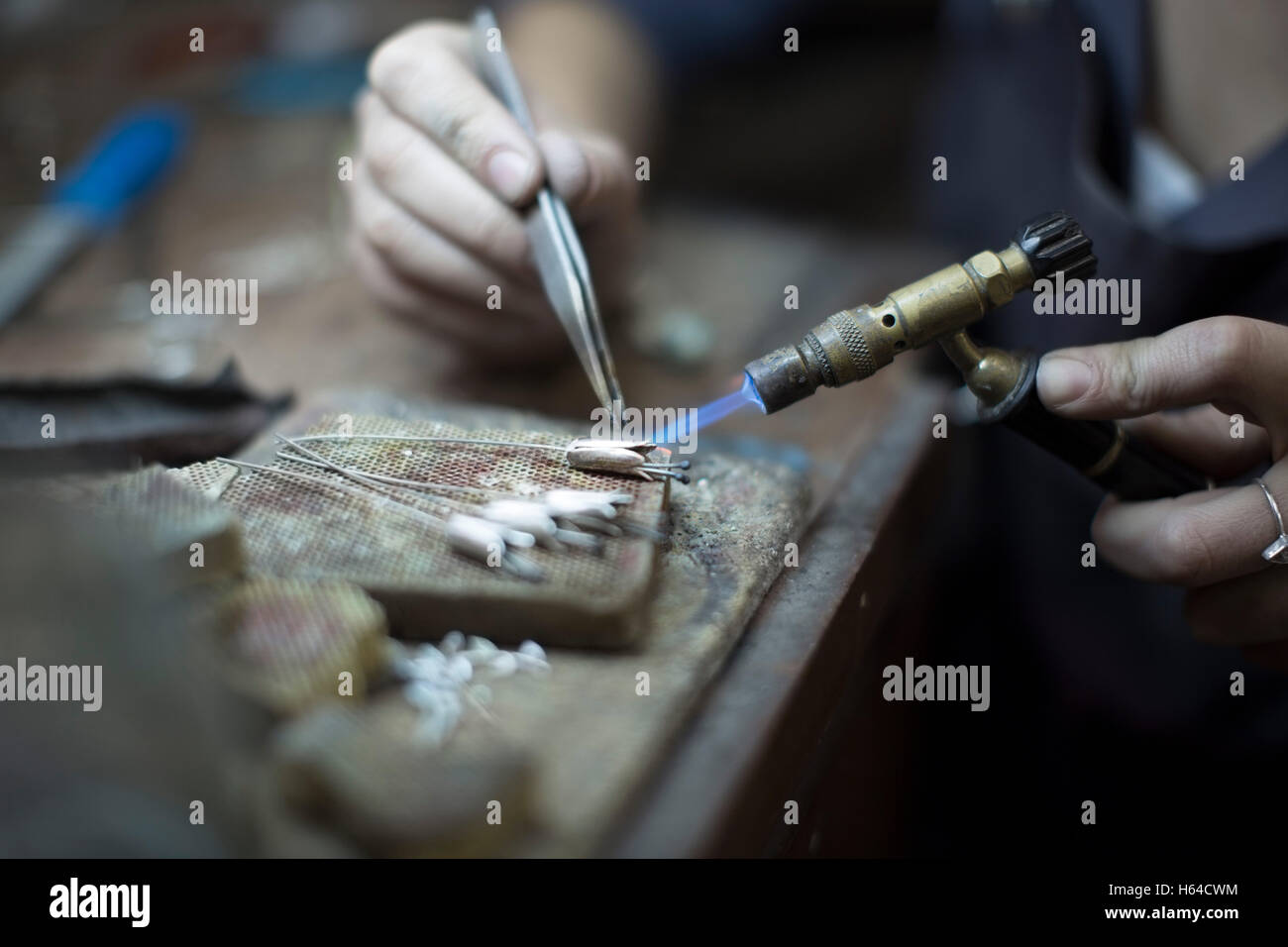 Goldsmith working with blow torch Stock Photo - Alamy