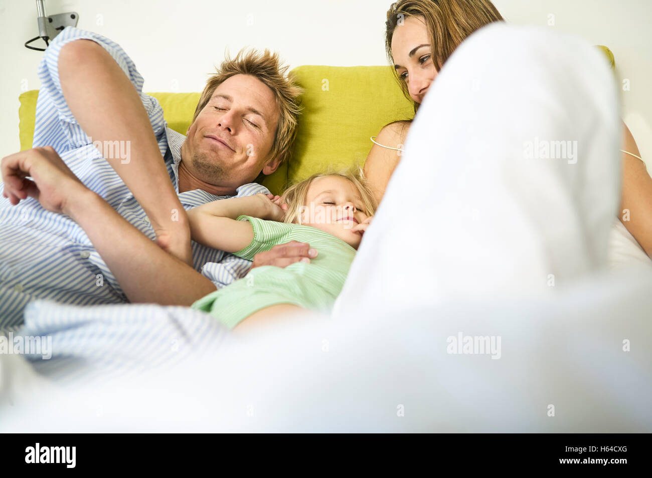 Family of three people sleeping in one bed hi-res stock photography and ...