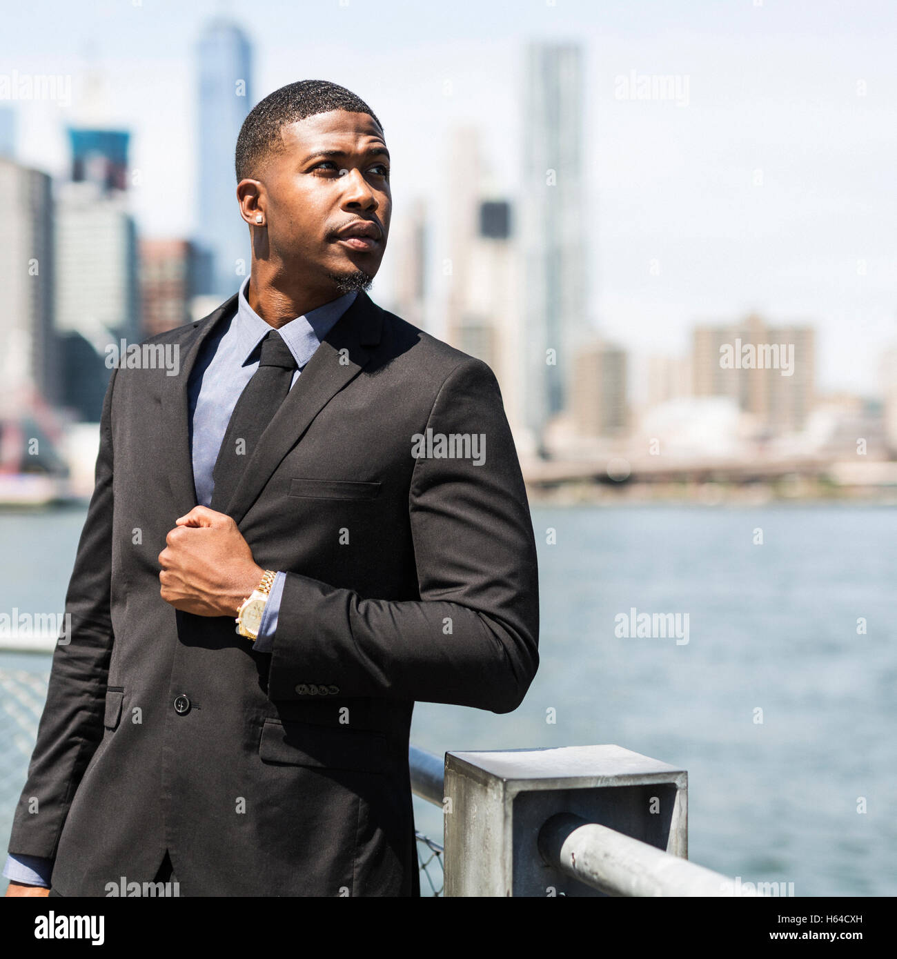USA, Brooklyn, portrait of businessman in front of Manhattan skyline ...